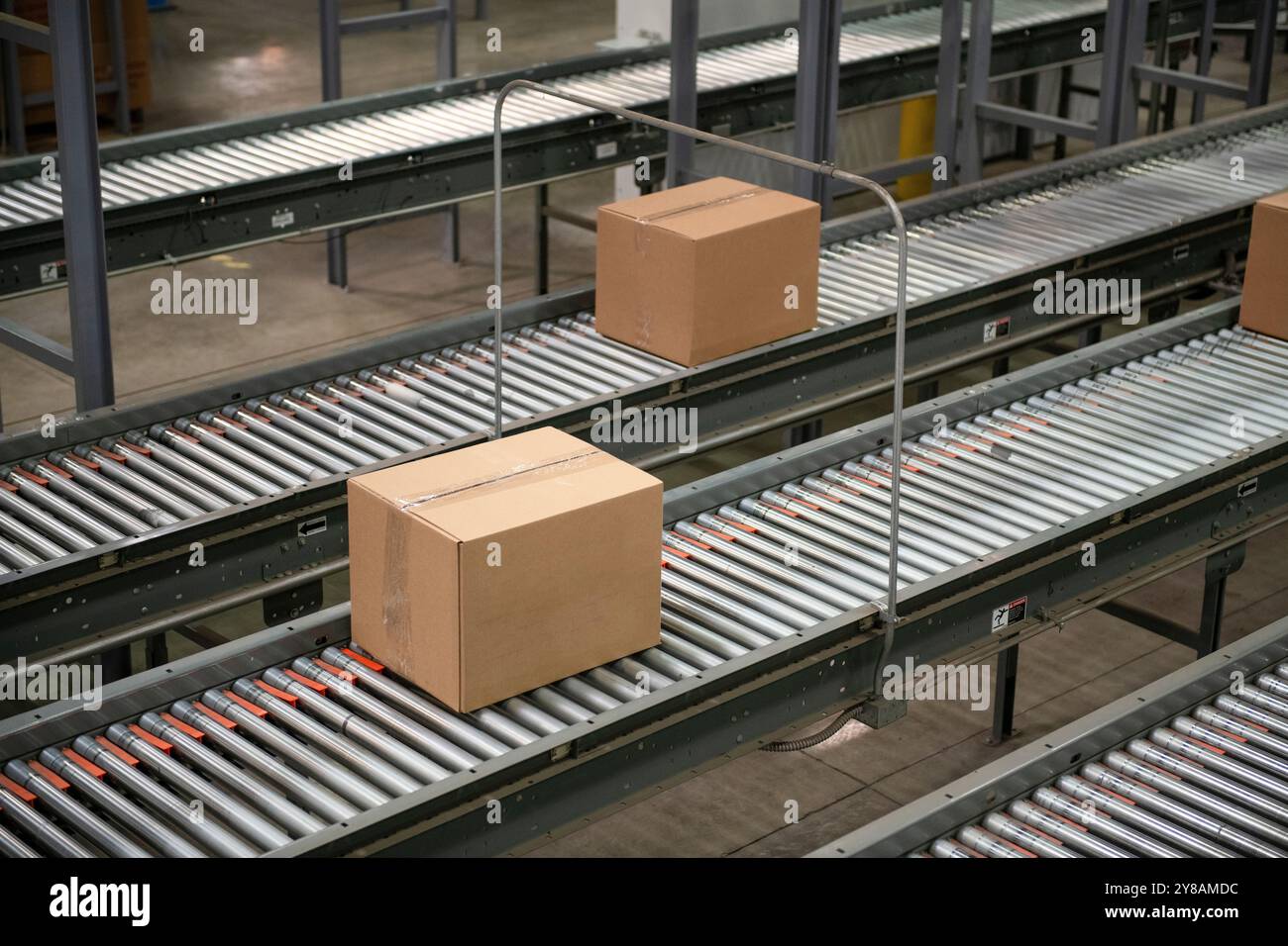 Cardboard shipping boxes moving on warehouse rollers Stock Photo - Alamy