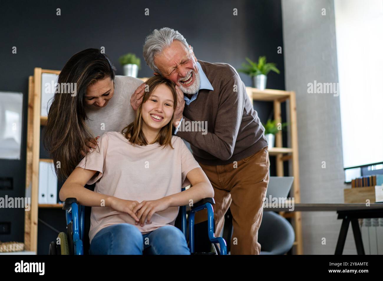 Happy multiethnic family with child with disability in wheelchair Stock ...