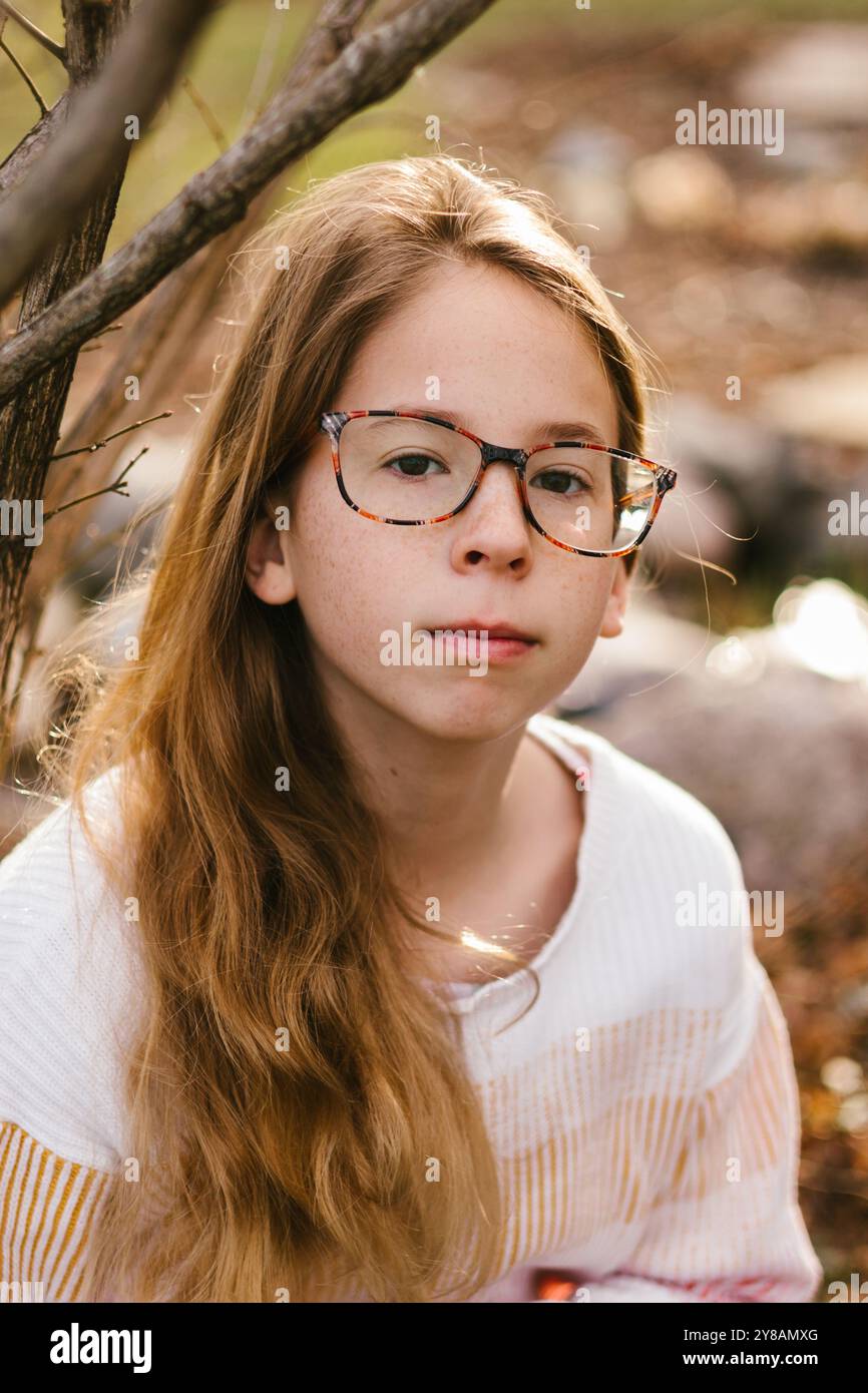 Tween blond girl in glasses outside in fall portrait Stock Photo - Alamy