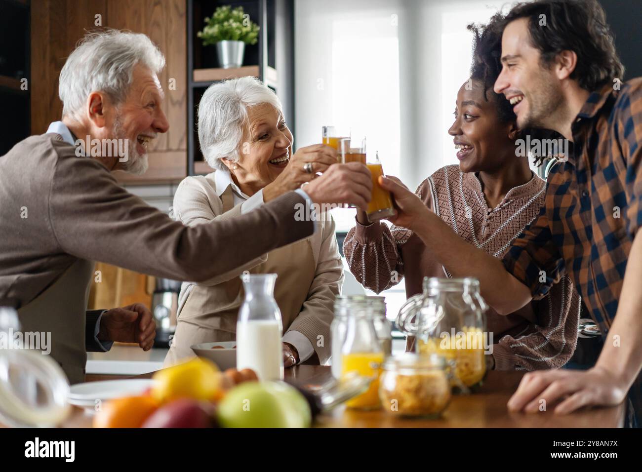 Multi generation multiethnic family having fun, talking around a ...