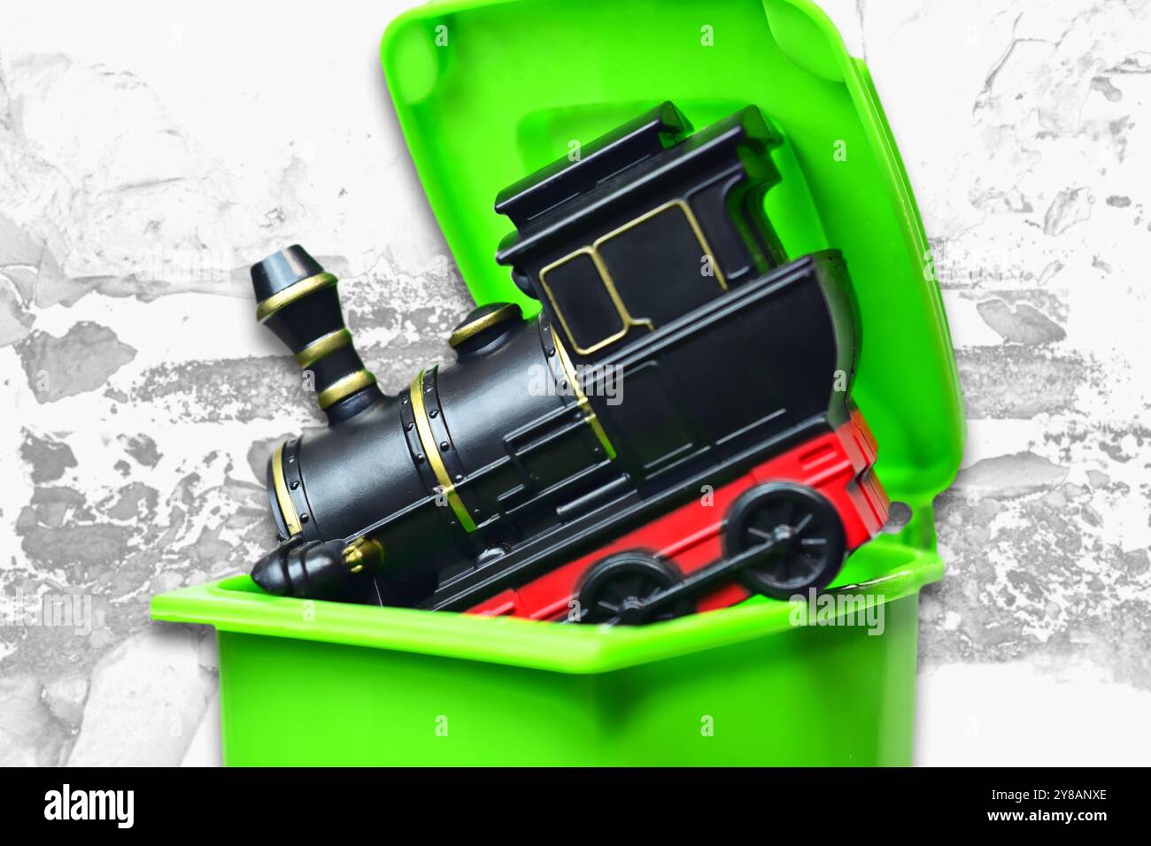 PHOTOMONTAGE, toy train in the trash can, symbolic photo of the railway ...