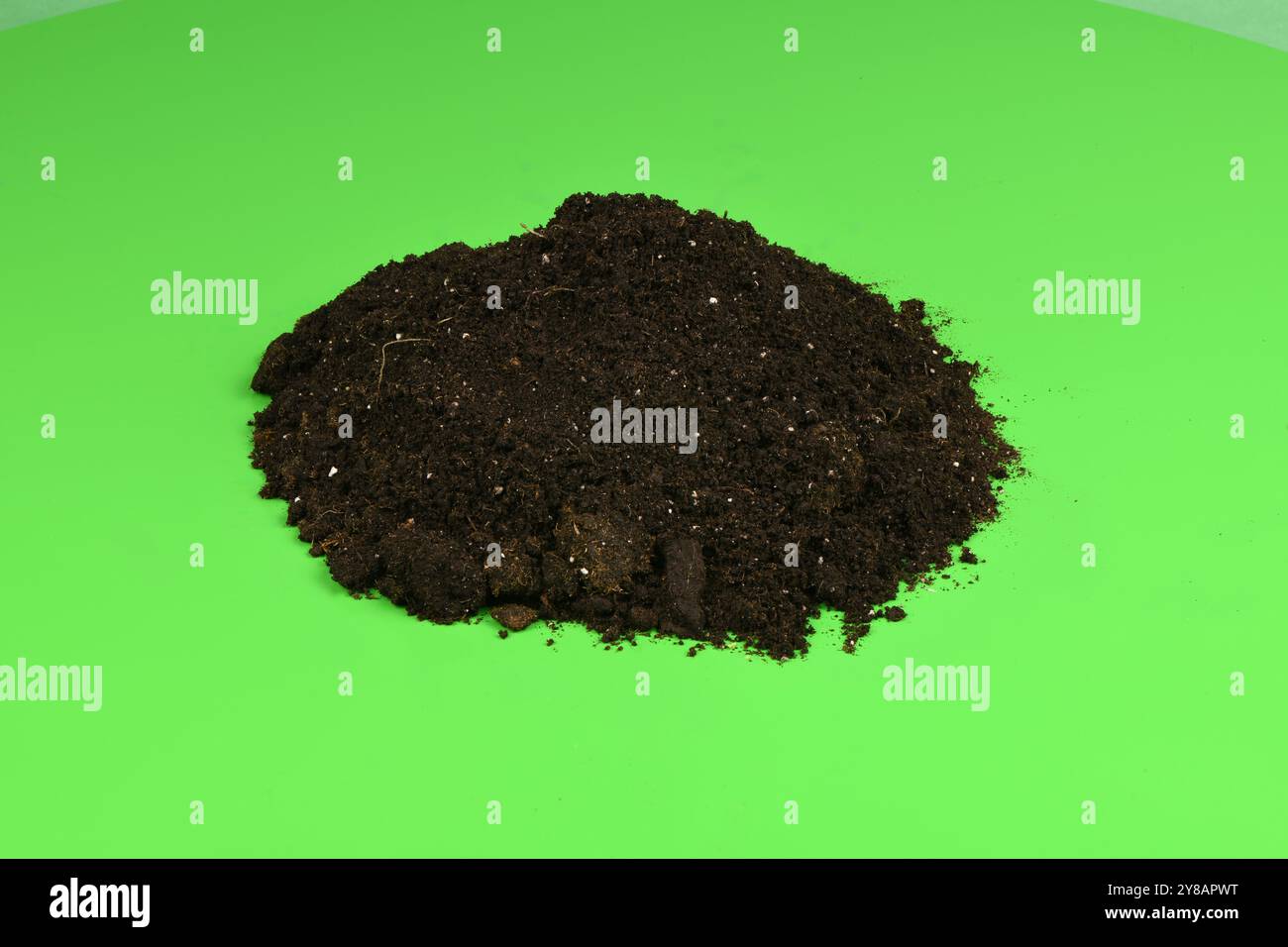 Heap of soil isolated on green background. Side view, natural black ...