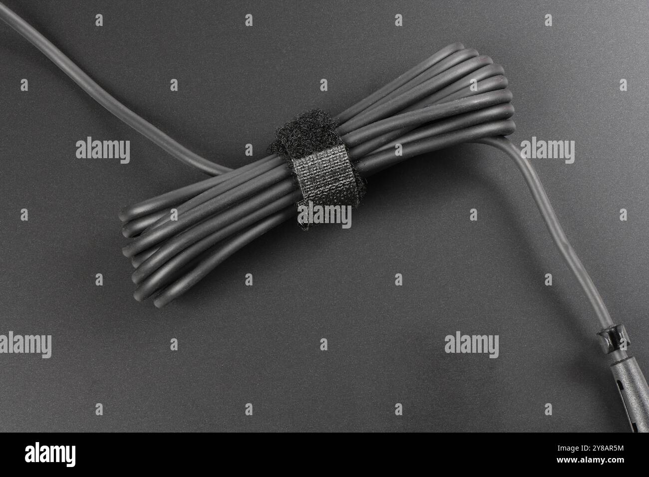 Close-up of black power cable. Black power cable neatly folded and ...