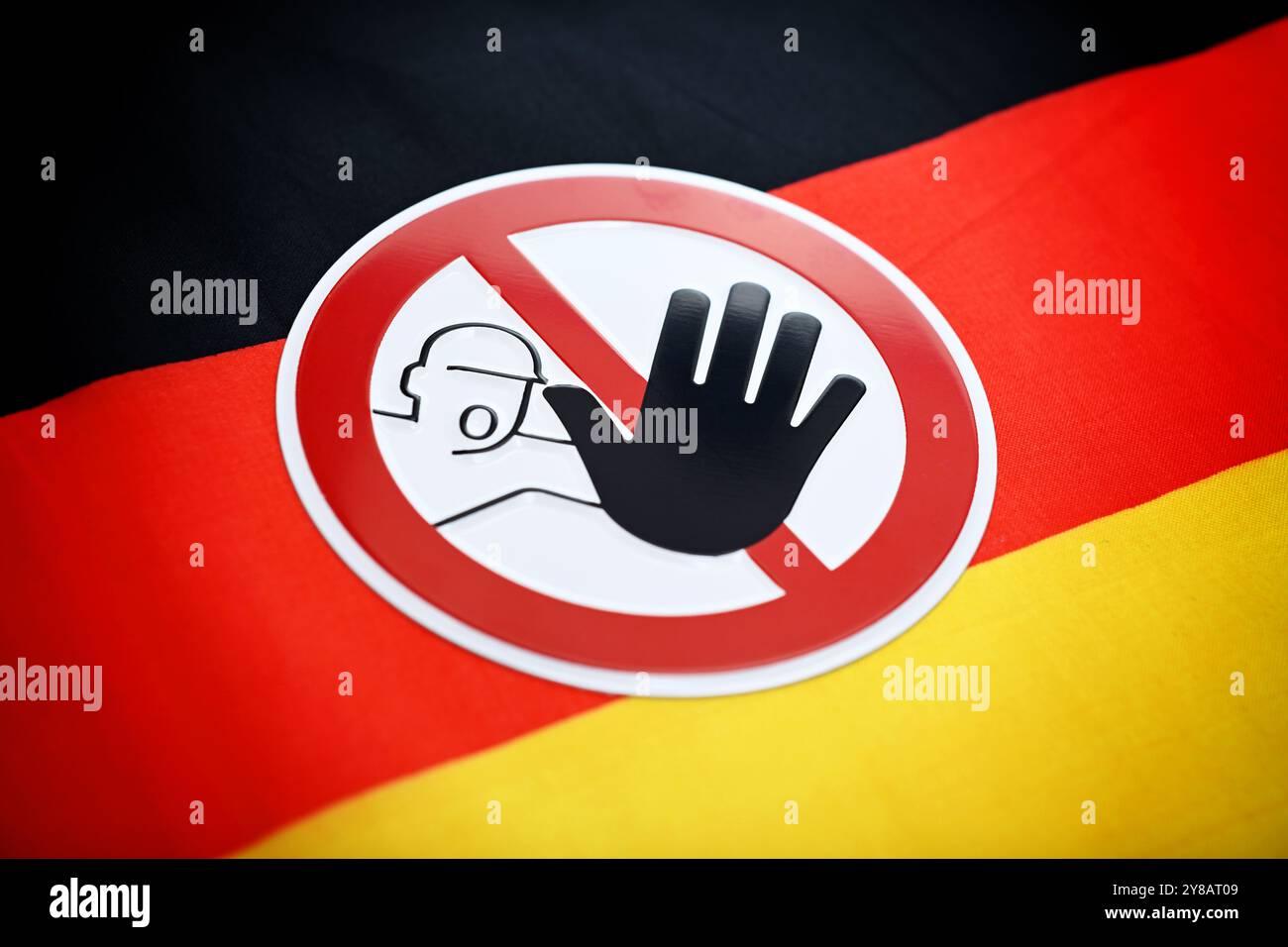 Warning sign on a German flag, symbolic photo for the defense of ...