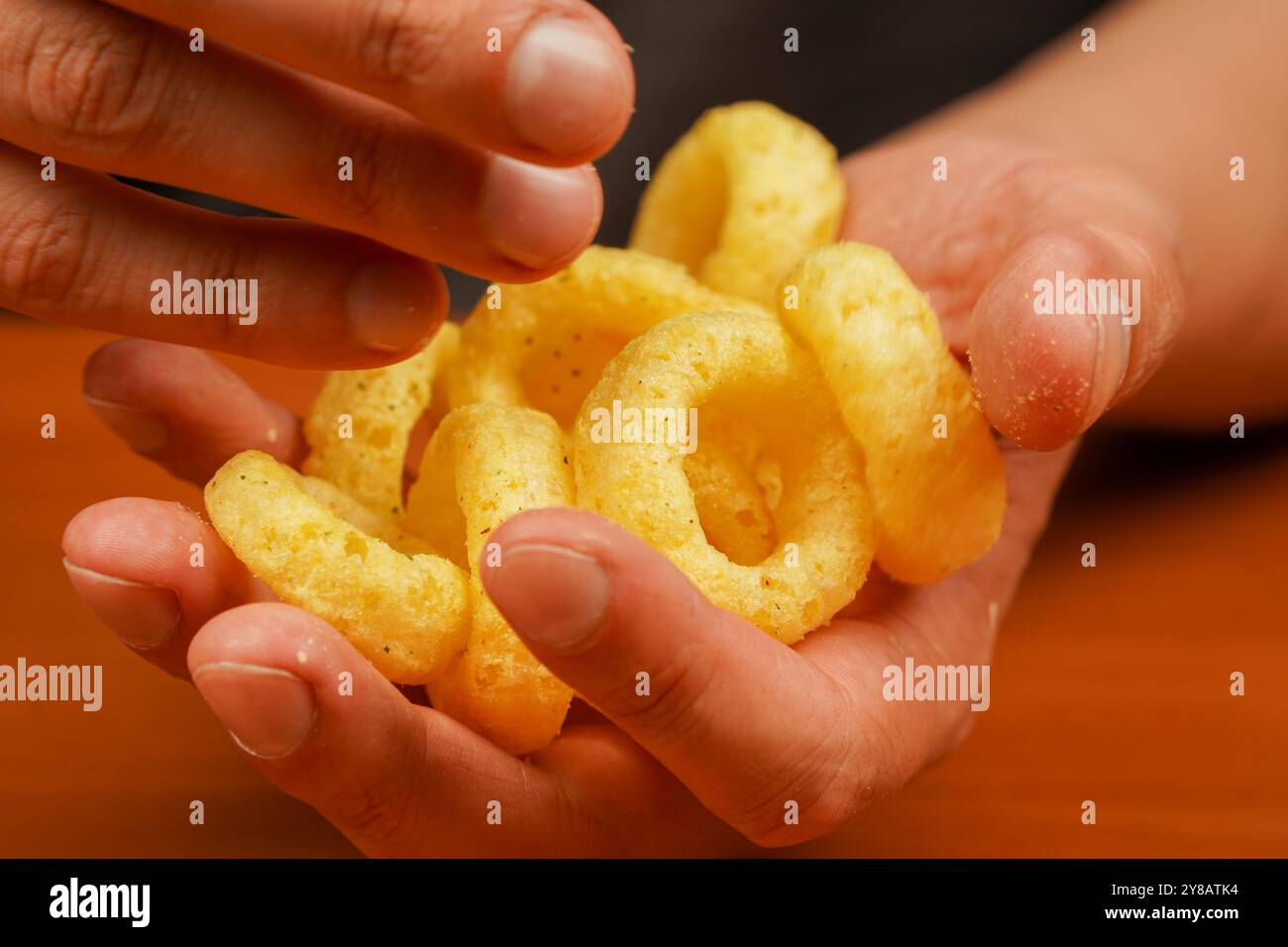 Eating onion rings. Onion ring. Deep fried onion rings. Snack for beer ...