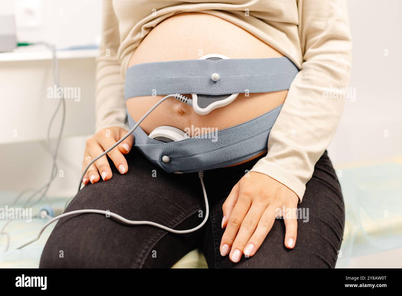 Woman pregnant checking fetal heart beat by fetal monitoring. Expectant ...