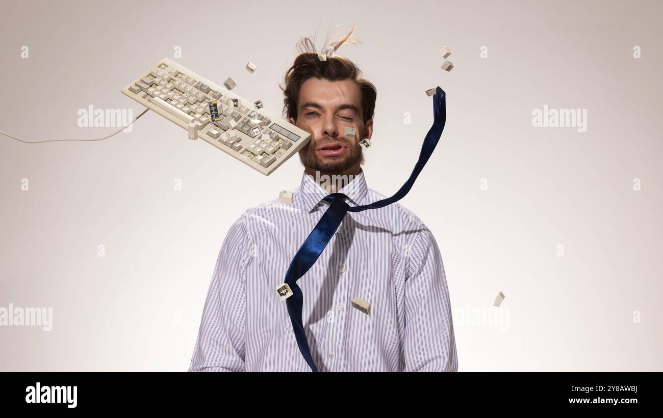 Digital overload and frustration. Flying keyboard strikes man's face ...
