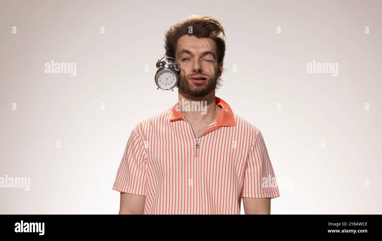 Alarm clock smashes into man's cheek, his face squished from force ...