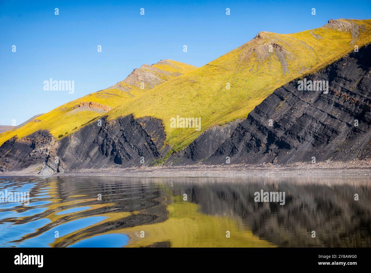 The beautiful banks of the Siberian river Lena are reflected in the ...