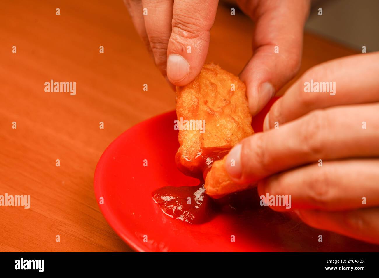 Man eating chicken nuggets. Holding chicken nuggets. Chicken nuggets ...