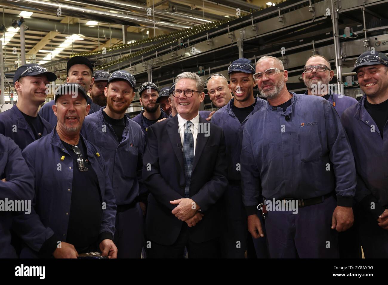 Britain's Prime Minister Keir Starmer with employees for photographers ...