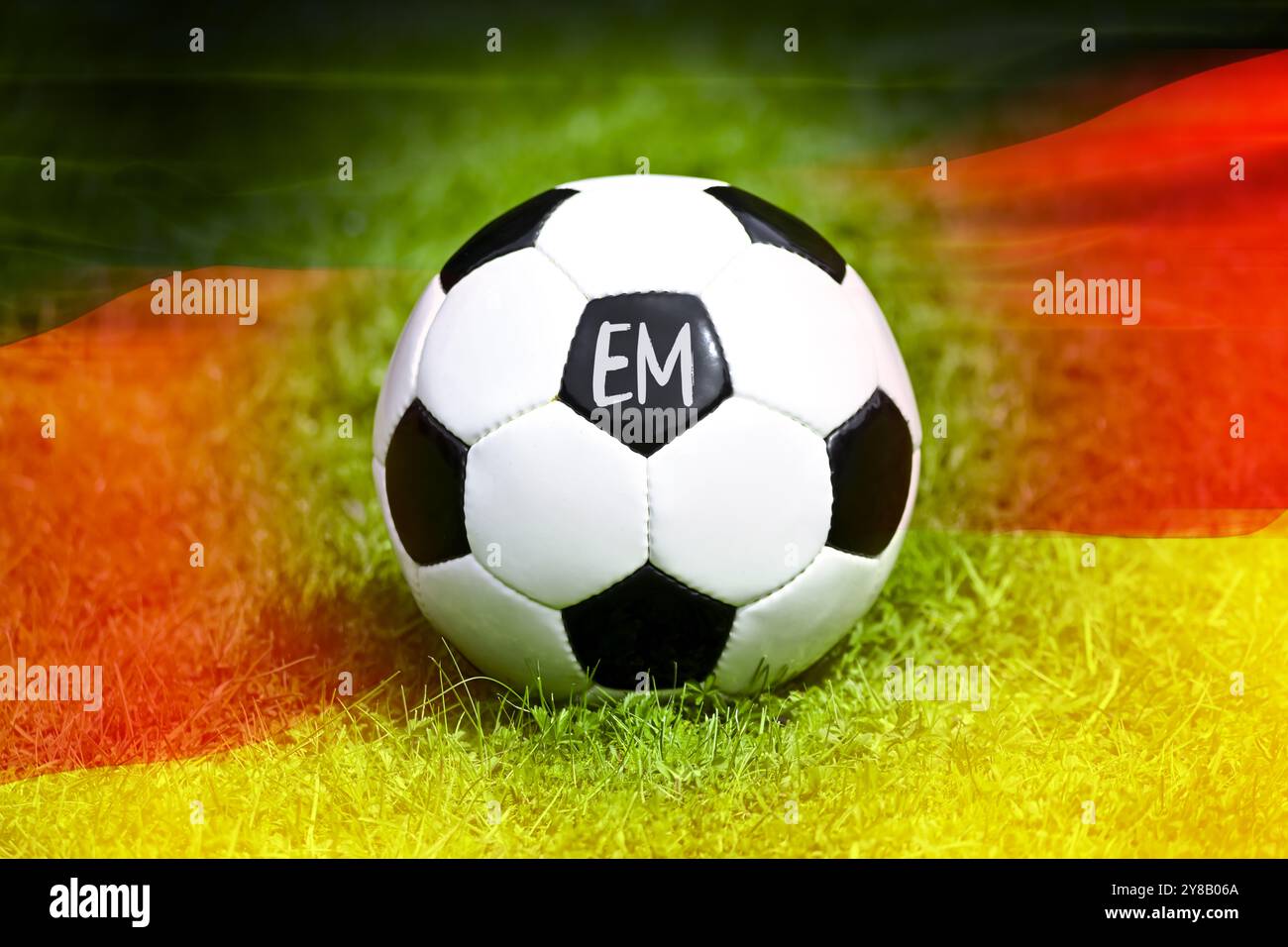 PHOTO MONTAGE, black and white leather football with the lettering EM ...