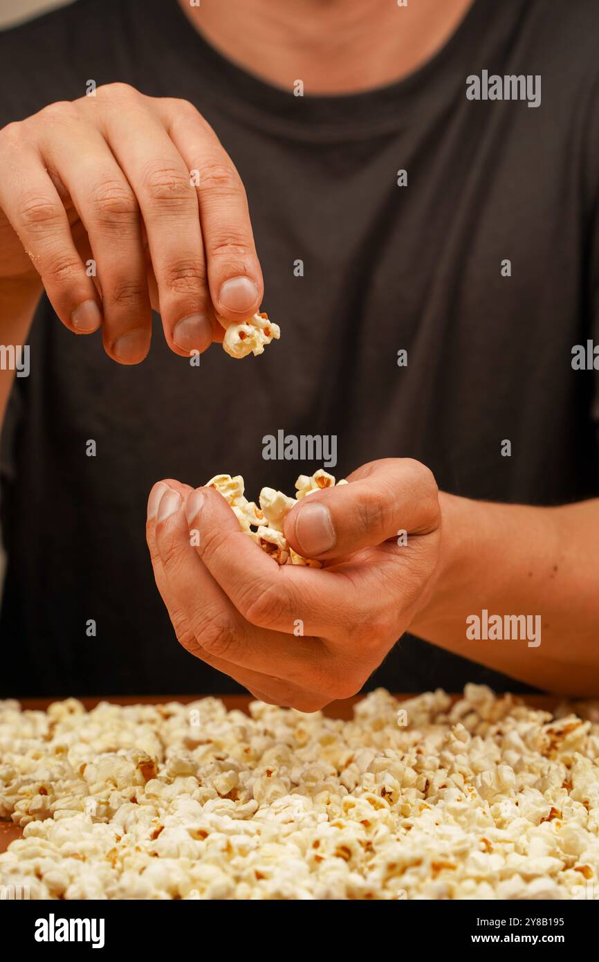 Man holding popcorn to eat. Delicious snack to eat in the cinema ...