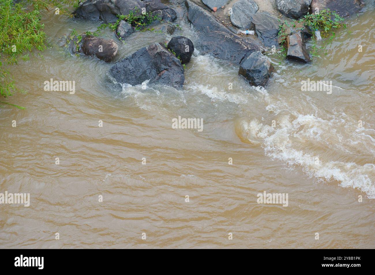Close Up Overhead view looking down at river rocks in a swift fast ...