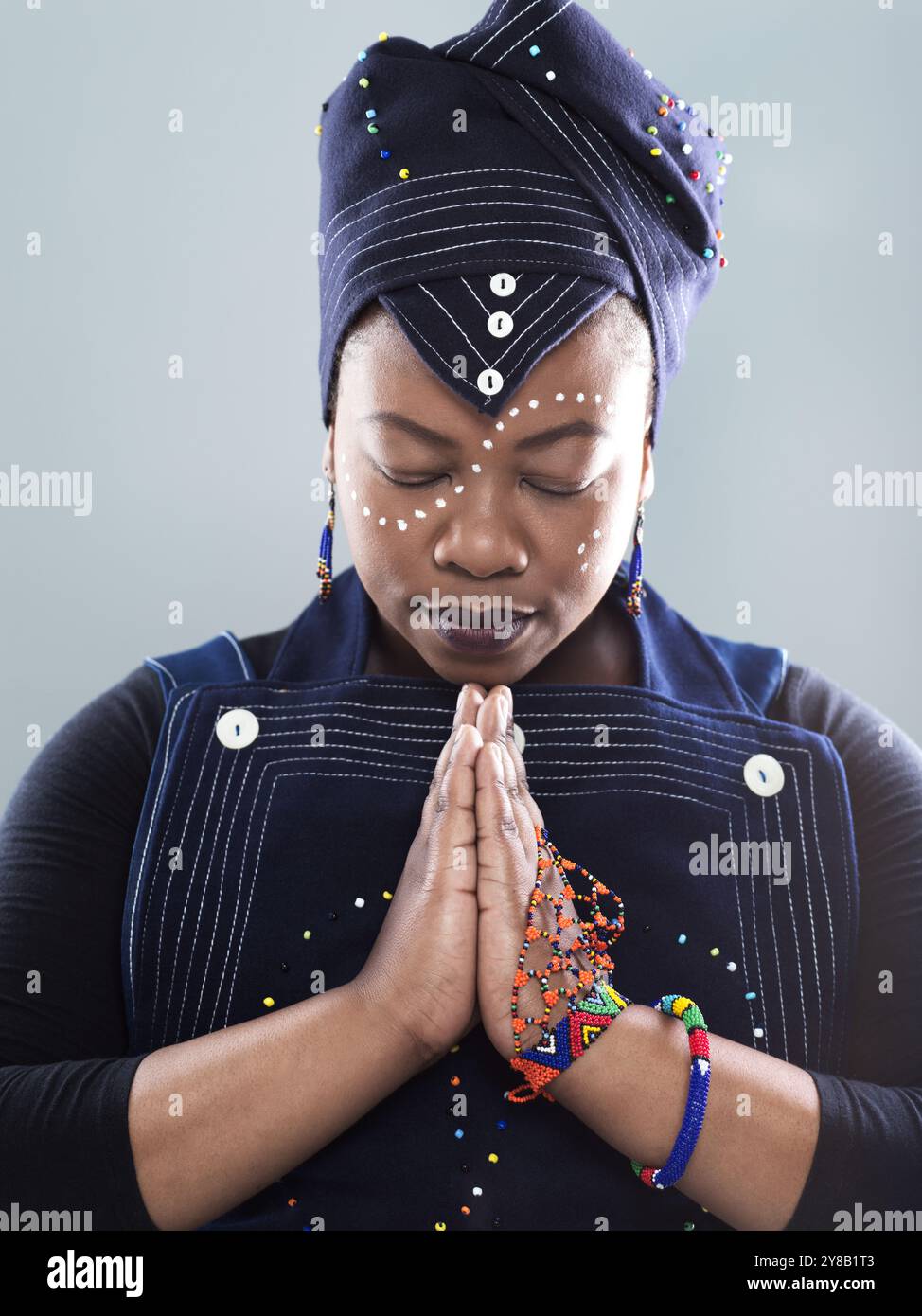 Traditional, african and woman in studio, praying and proud of culture ...