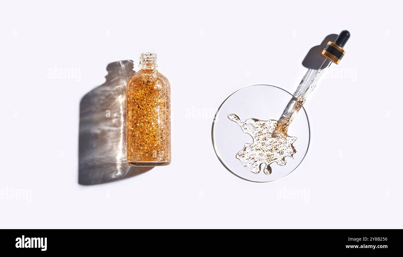 Glowing cosmetic bottle with dropper and gel texture on clean surface ...