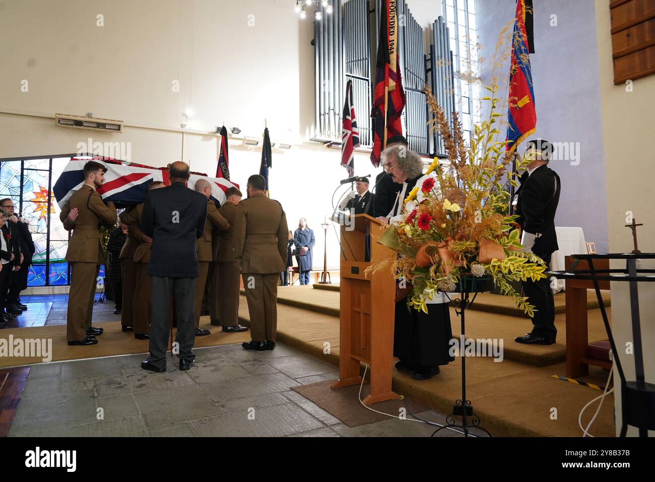 The bearer party carry the coffin into the service at the funeral of ...