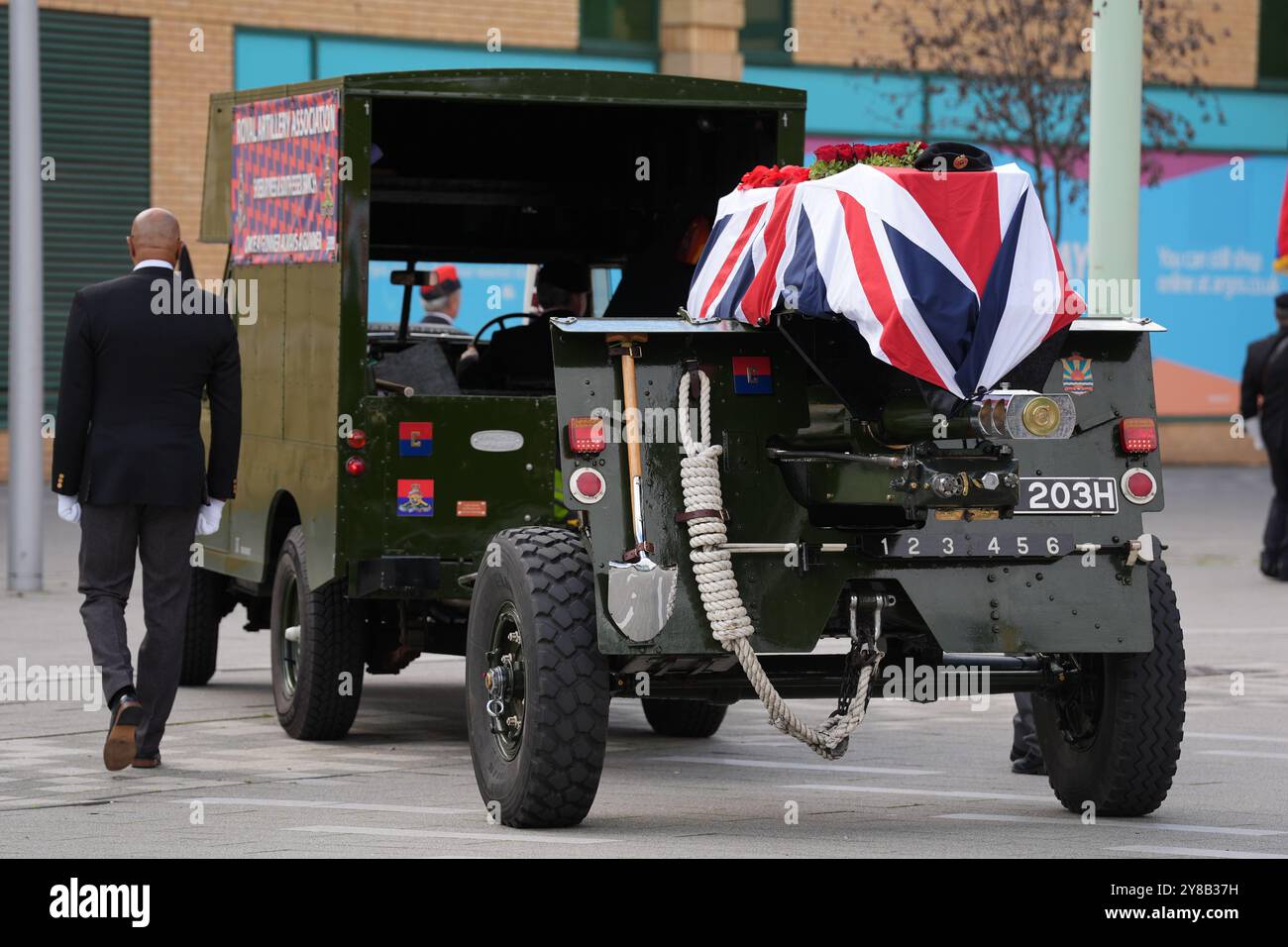The coffin, draped in the Union Flag, is escorted on a gun carriage at ...