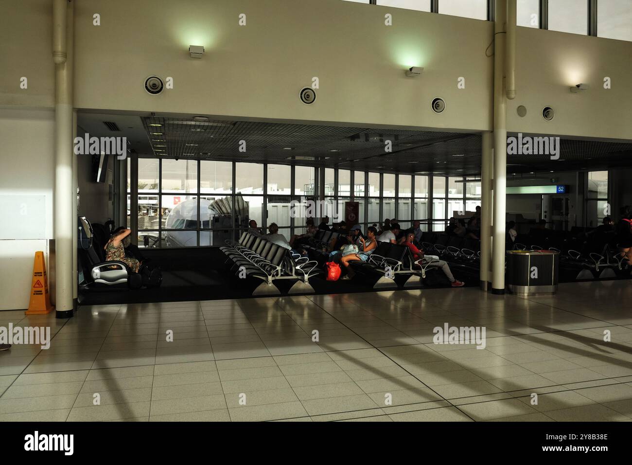 Waiting to board a flight at Sydney Airport terminal, a plane attached ...