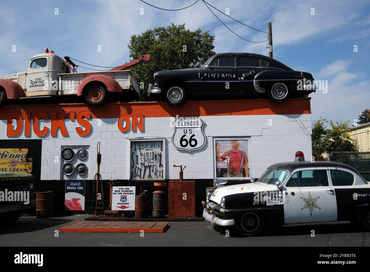 View of old car, Police Car and Tow Truck at Dick's on Route 66. A well ...