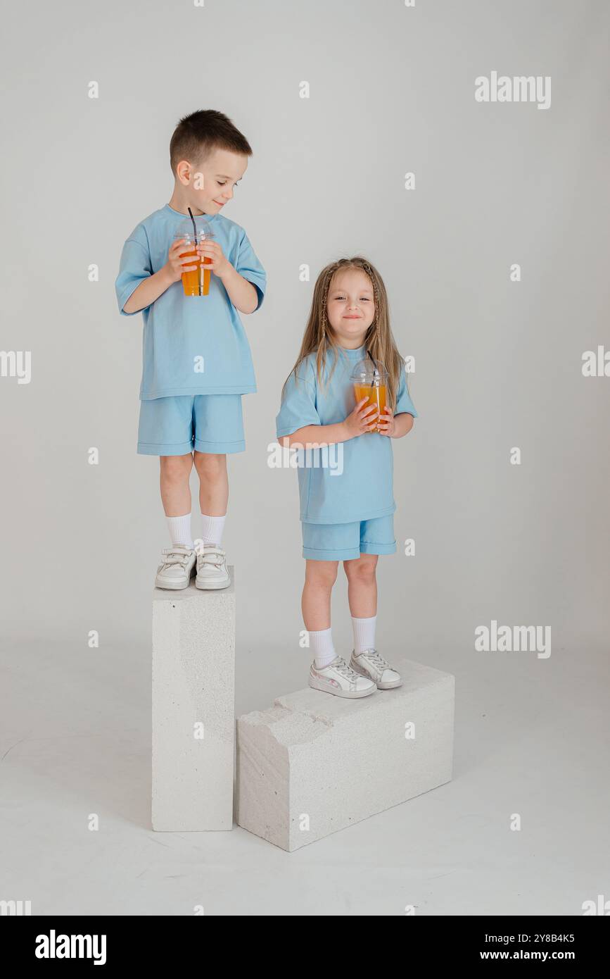 Two young children have fun in the studio on an white background Stock ...