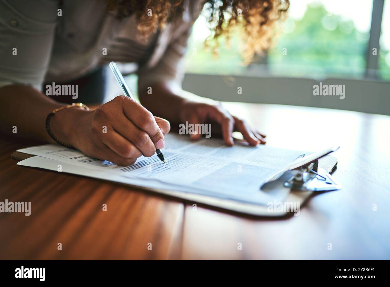 Hands, paperwork and woman sign contract, insurance policy and filling ...