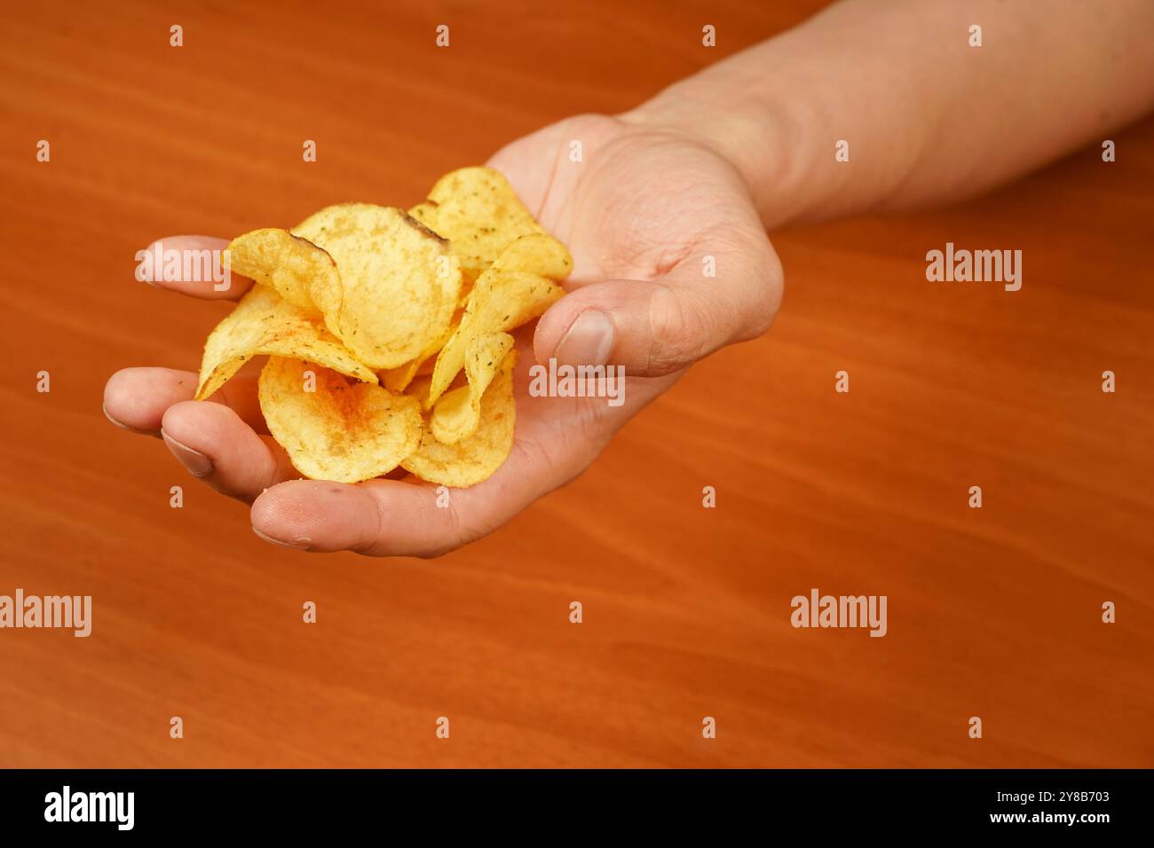Fast food. Junk food. Unhealthy lifestyle. Man eating potato chips ...
