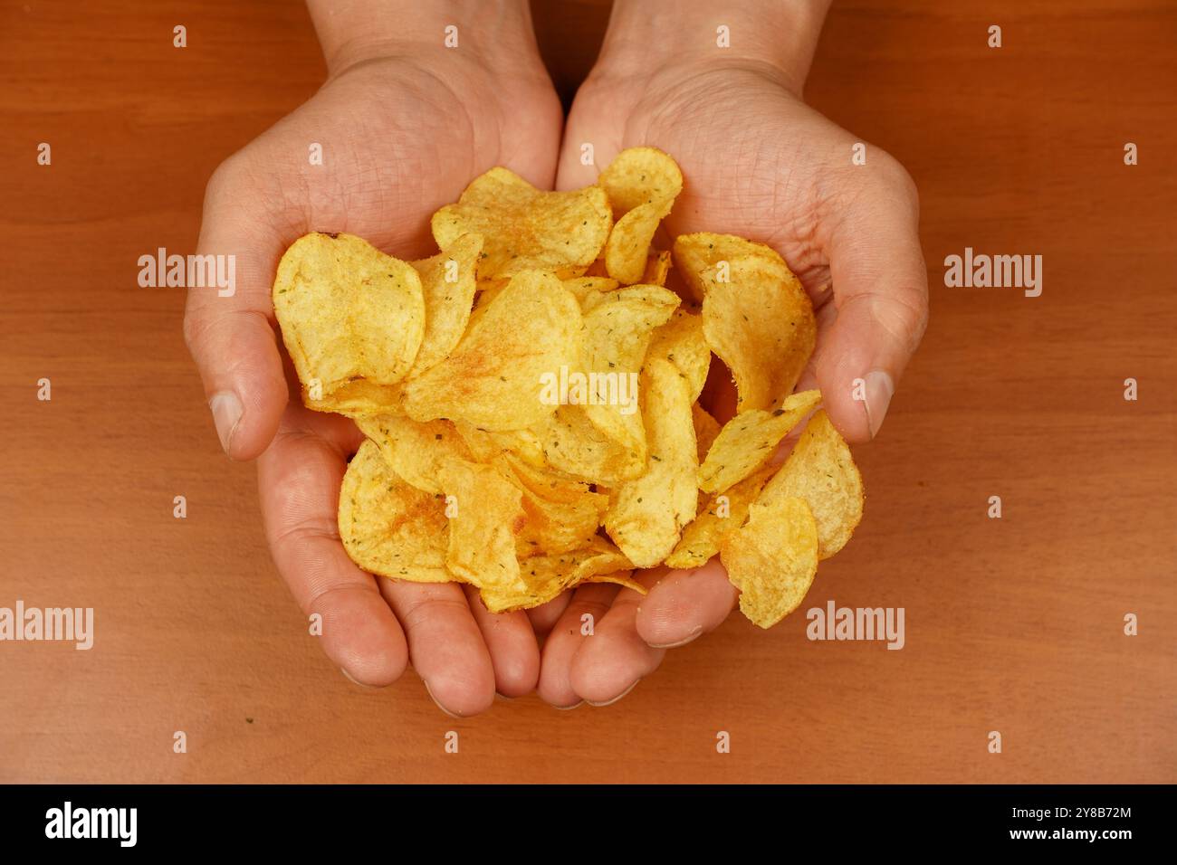 Fast food. Junk food. Unhealthy lifestyle. Man eating potato chips ...