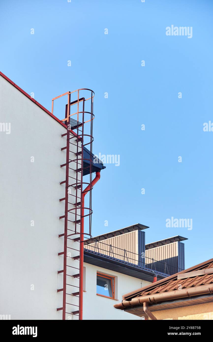 Secure stairs to the roof of the building. Metal. Red. Industrial ...