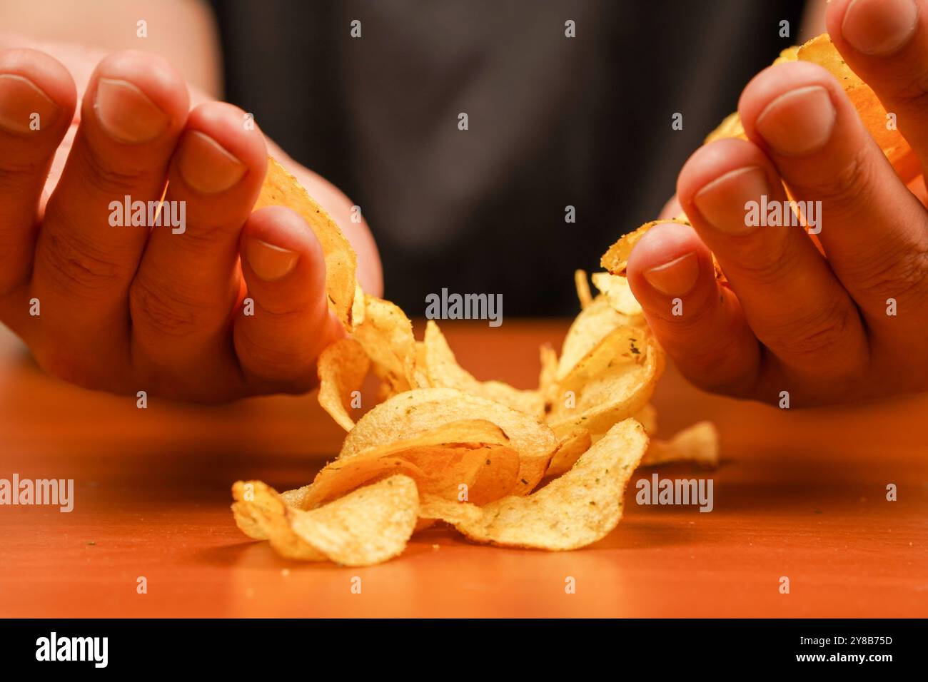 Fast food. Junk food. Unhealthy lifestyle. Man eating potato chips ...