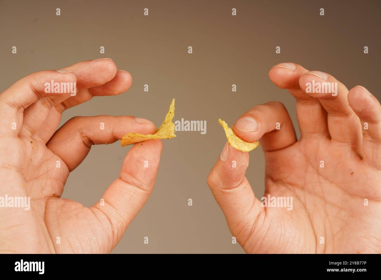 Fast food. Junk food. Unhealthy lifestyle. Man eating potato chips ...