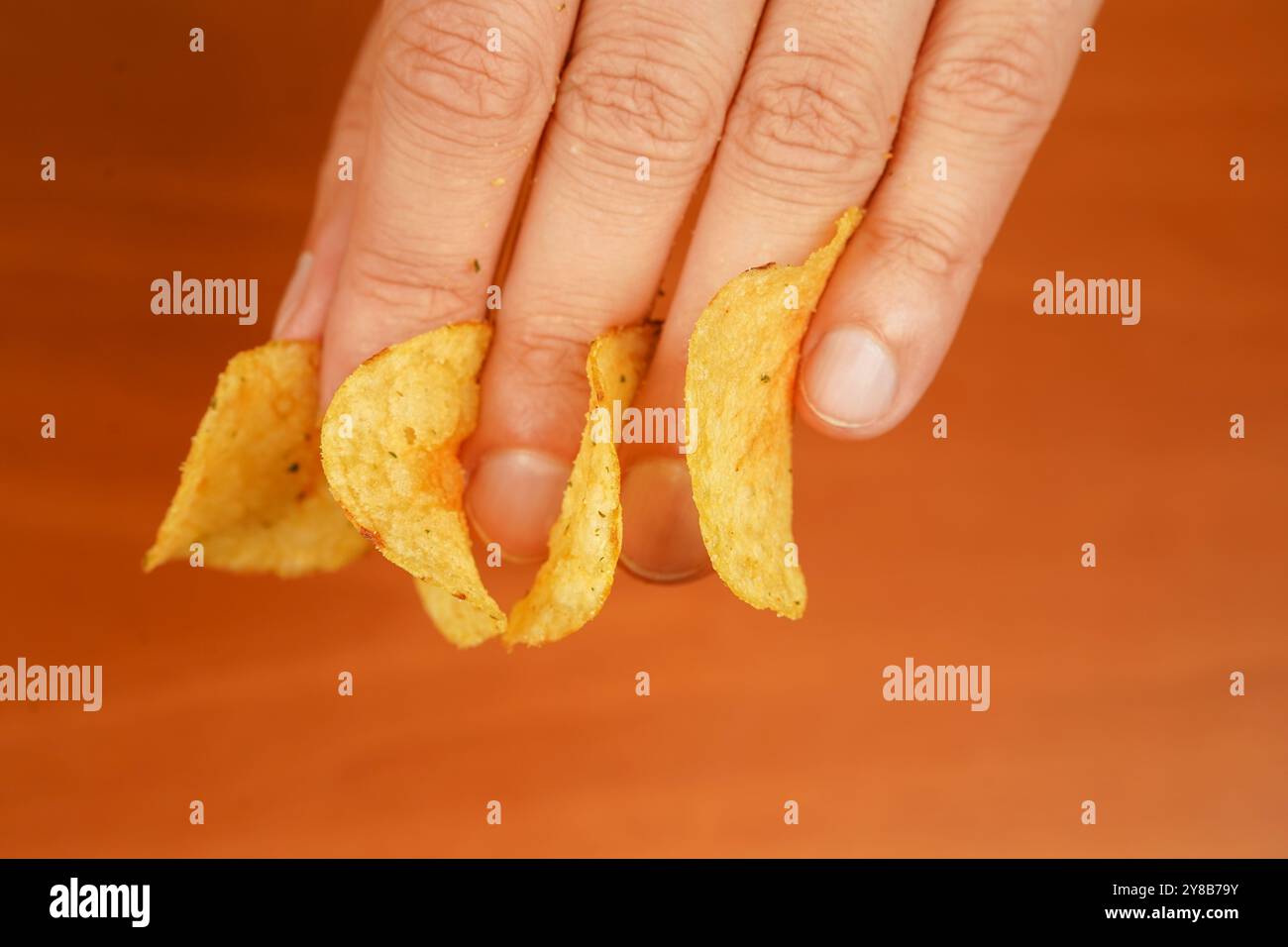 Fast food. Junk food. Unhealthy lifestyle. Man eating potato chips ...