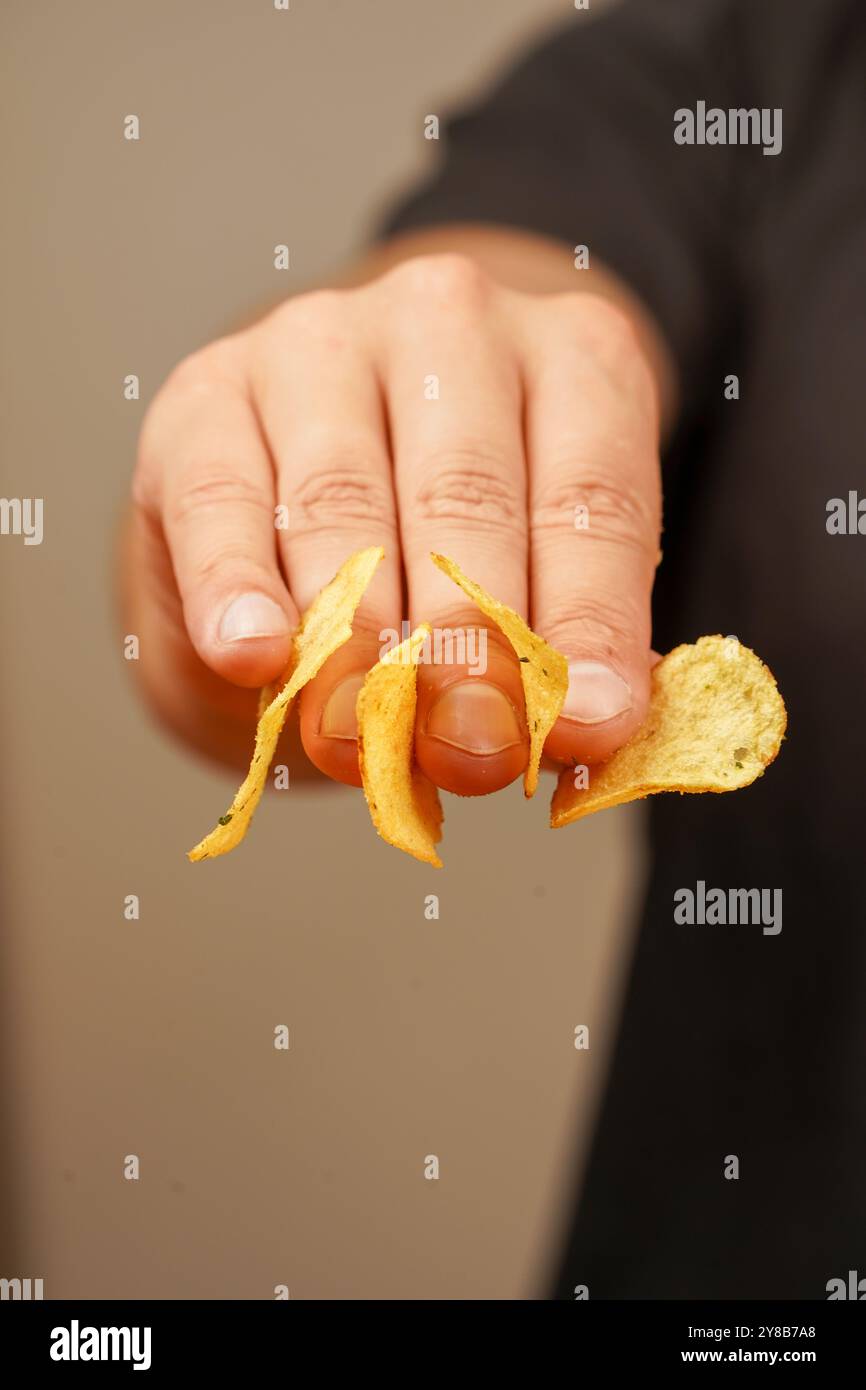 Unhealthy lifestyle. Man eating potato chips. Fast food. Junk food ...