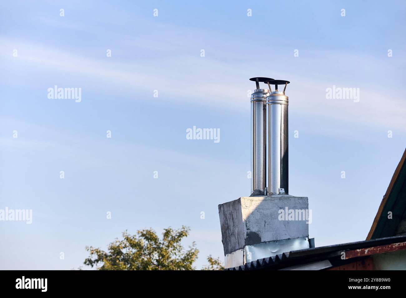 Two modern style chimneys from oven and fireplace stacked stainless ...