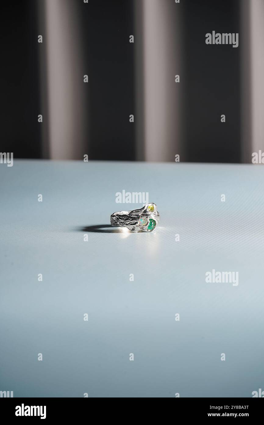 Side view of gem ring detail. A ring in a modern avant-garde style ...