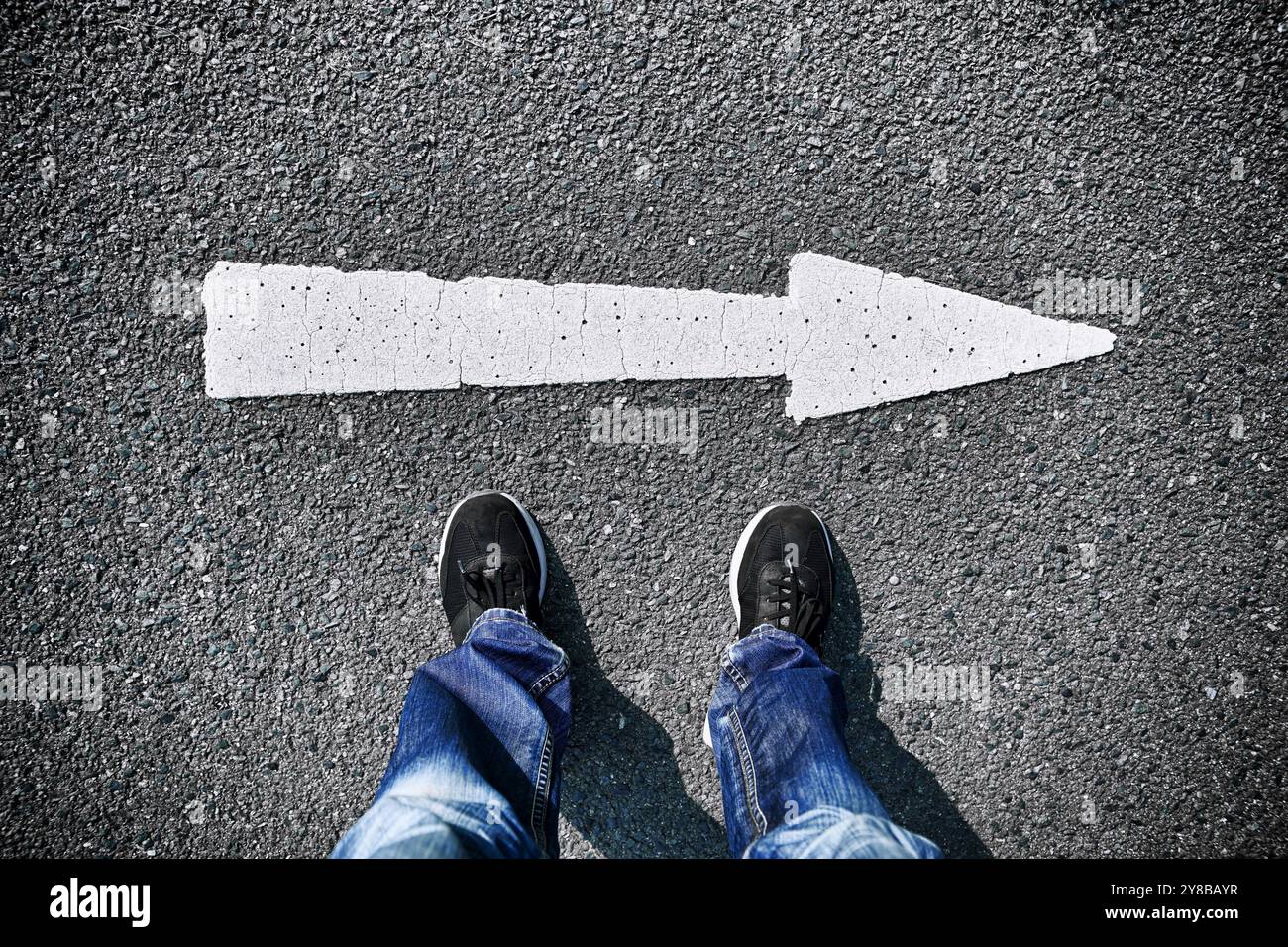 Legs standing in front of an arrow pointing to the right, symbolic ...