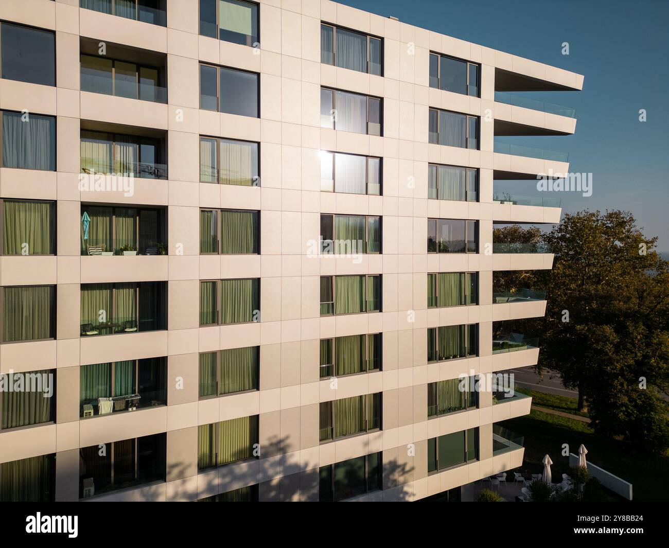 A drone flyby showcasing a modern high-rise building with sleek ...