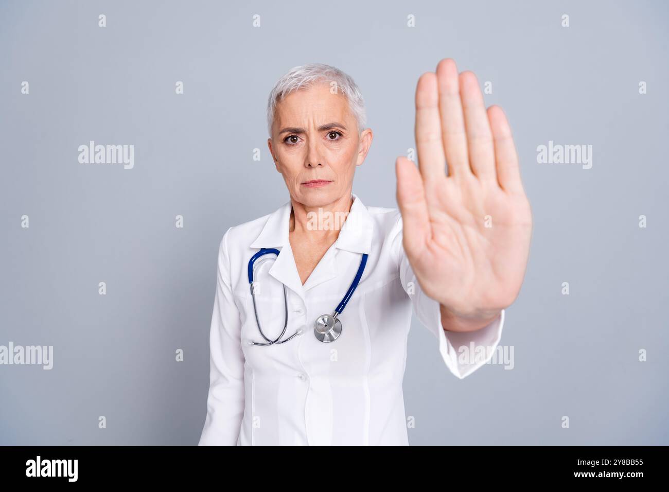 Photo of beautiful woman qualified specialist surgeon stop sign ...