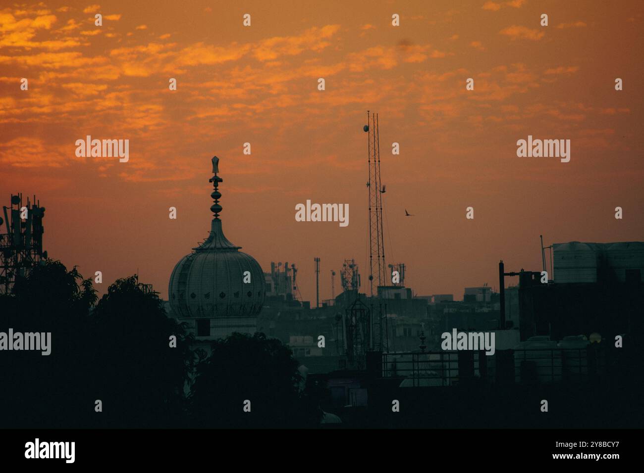 A sunset cityscape blends a traditional dome with modern structures ...