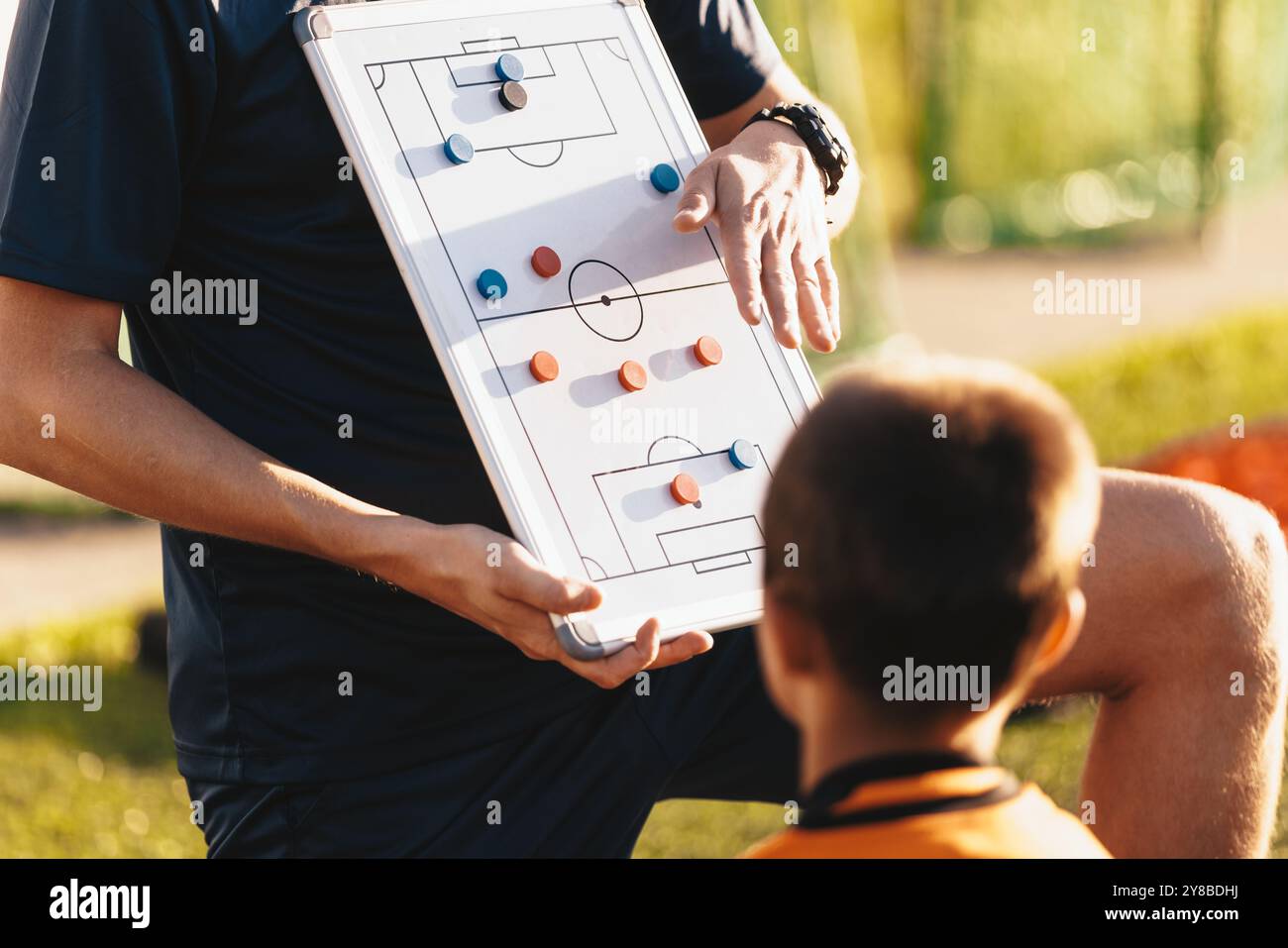 Football Coach Using Soccer Tactics Strategy Board. Coach explaining ...