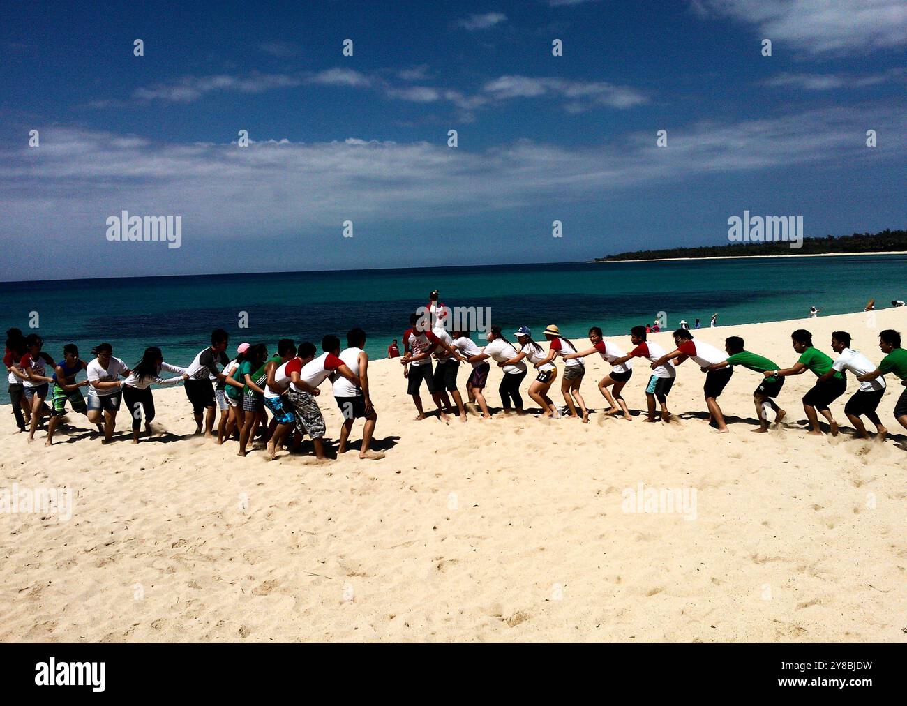 A team building activity of people playing in beach Stock Photo - Alamy