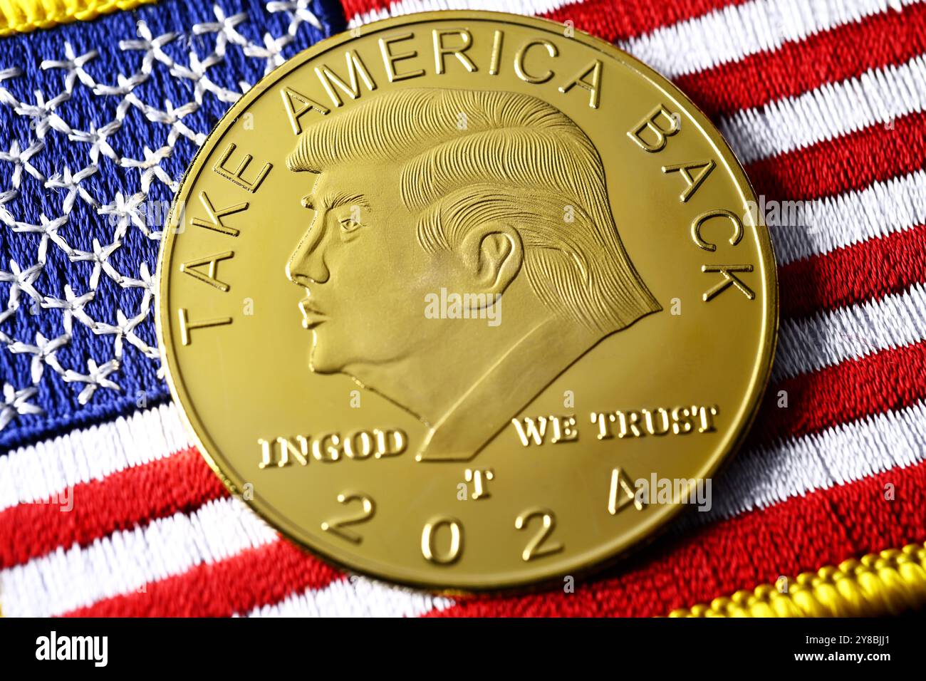 Campaign coin with the portrait of Donald Trump on the US flag ...