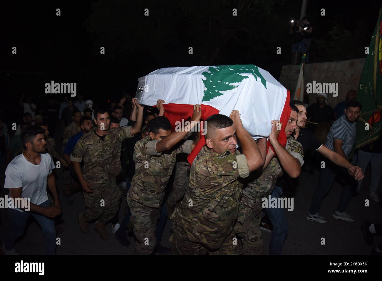 Al Minieh. 4th Oct, 2024. People attend a funeral of a Lebanese soldier ...