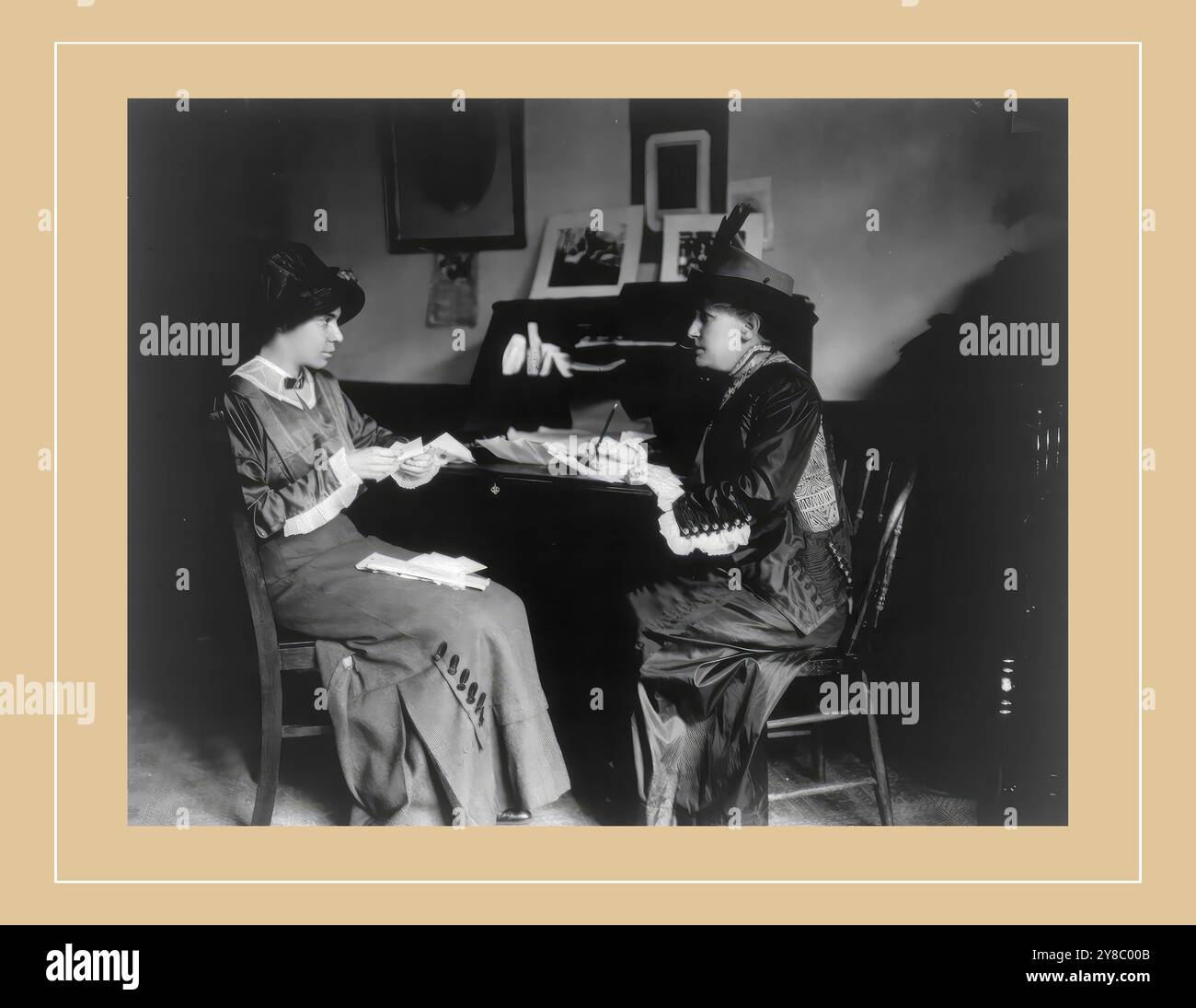 Mrs. Helen Gardener and Miss Alice Paul, seated, full-length portrait, at desk, between ca. 1908 ...
