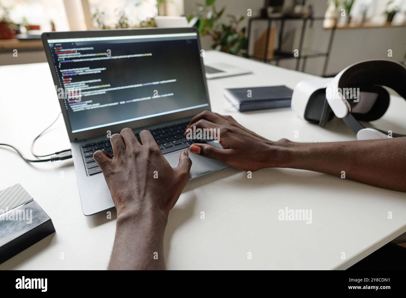 Unrecognizable male hands typing on keyboard, eclectic devices on top ...