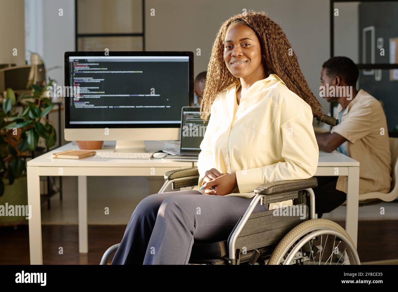 Portrait of female African American programmer with disability posing ...