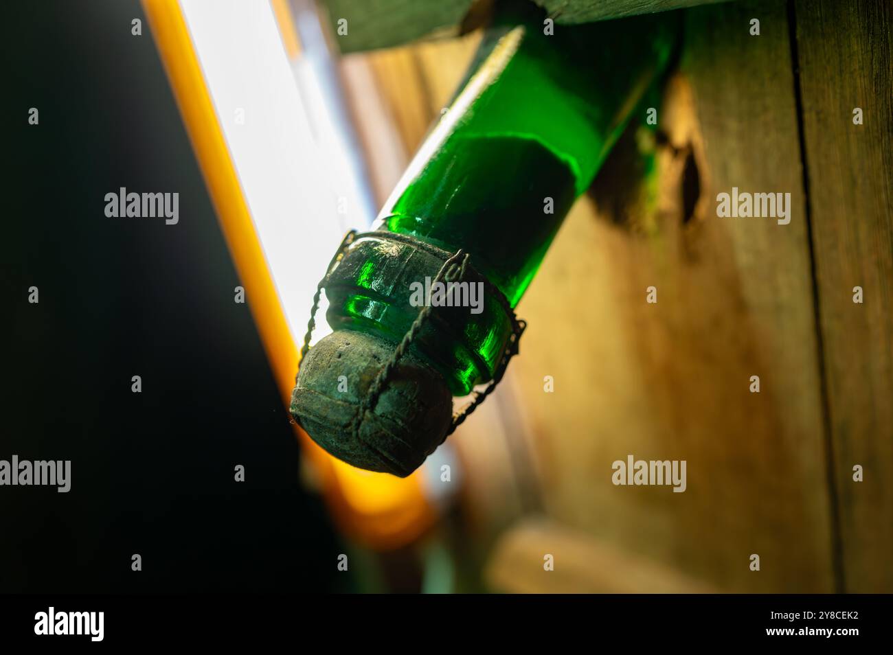 Champagne bottles on pupitre riddling racks in deep and long ...