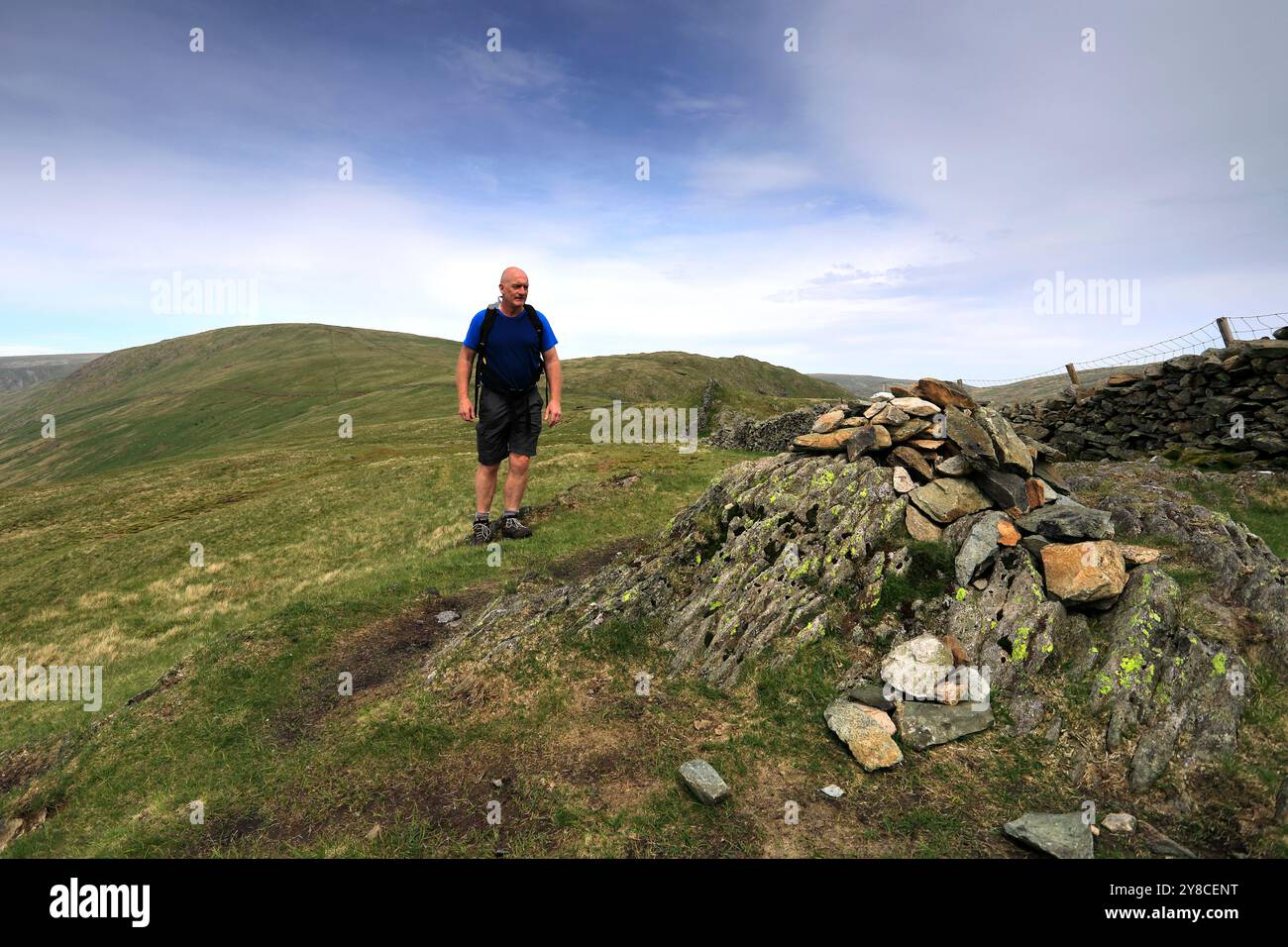 Walker at the Summit Cairn of Shipman Knotts fell, above the village of ...