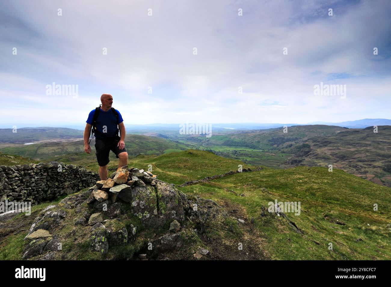 Walker at the Summit Cairn of Shipman Knotts fell, above the village of ...