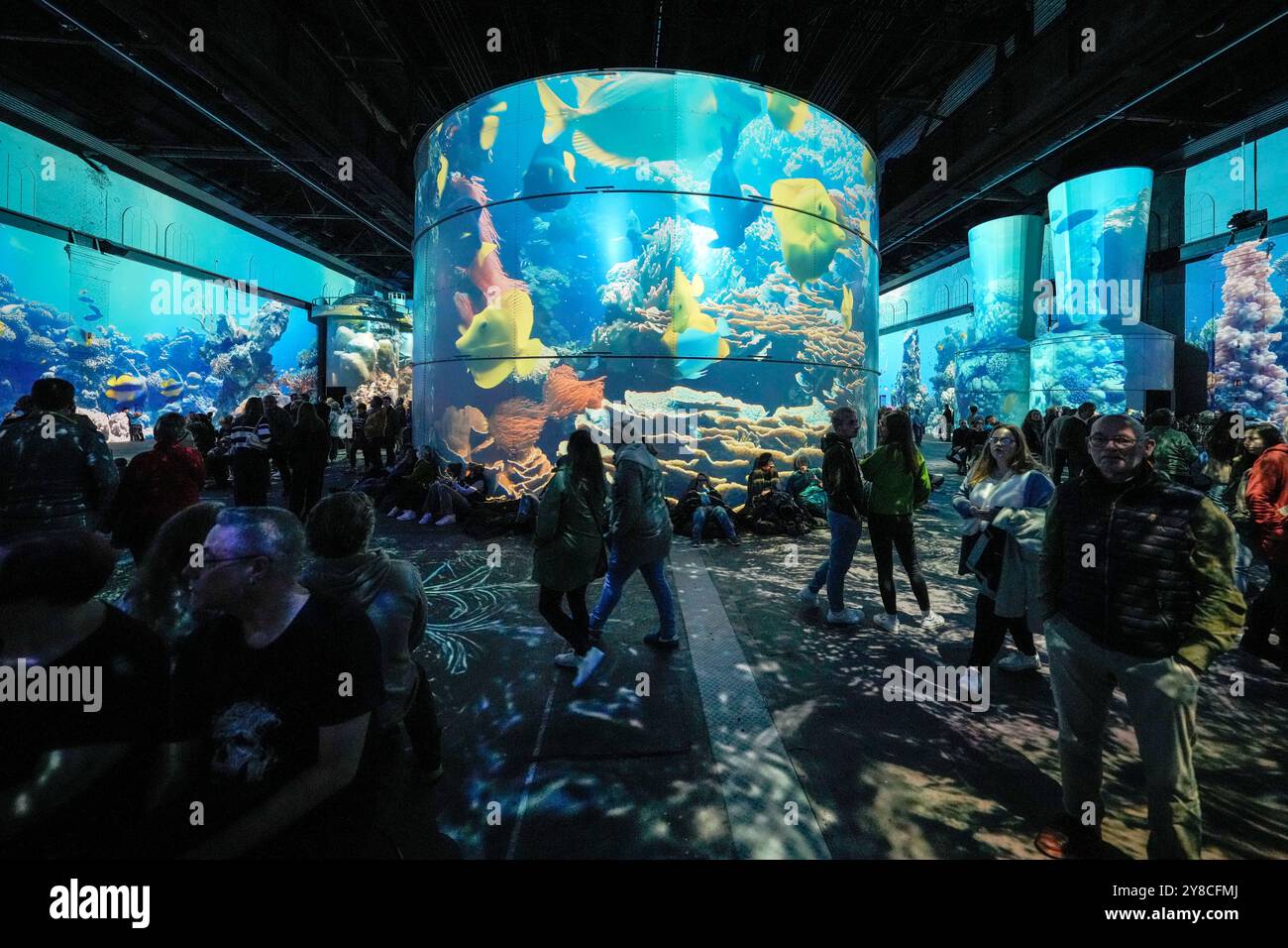Visitors watch the audiovisual presentation Ocean Odyssey, projected on ...